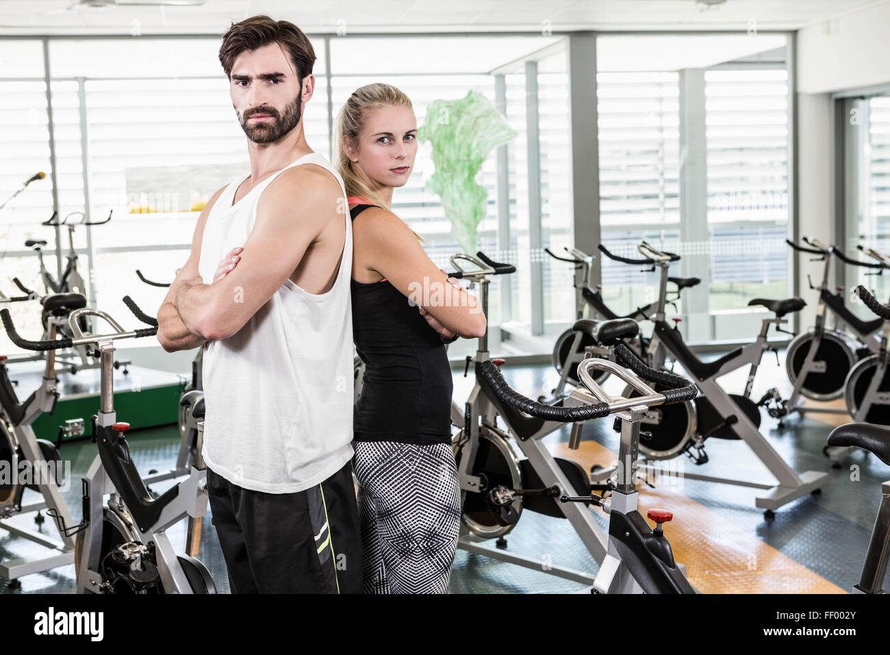 Back to back arms crossed hi-res stock photography and images - Alamy