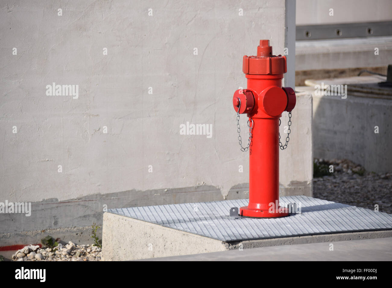 red Hydrant long a construnction site Stock Photo - Alamy