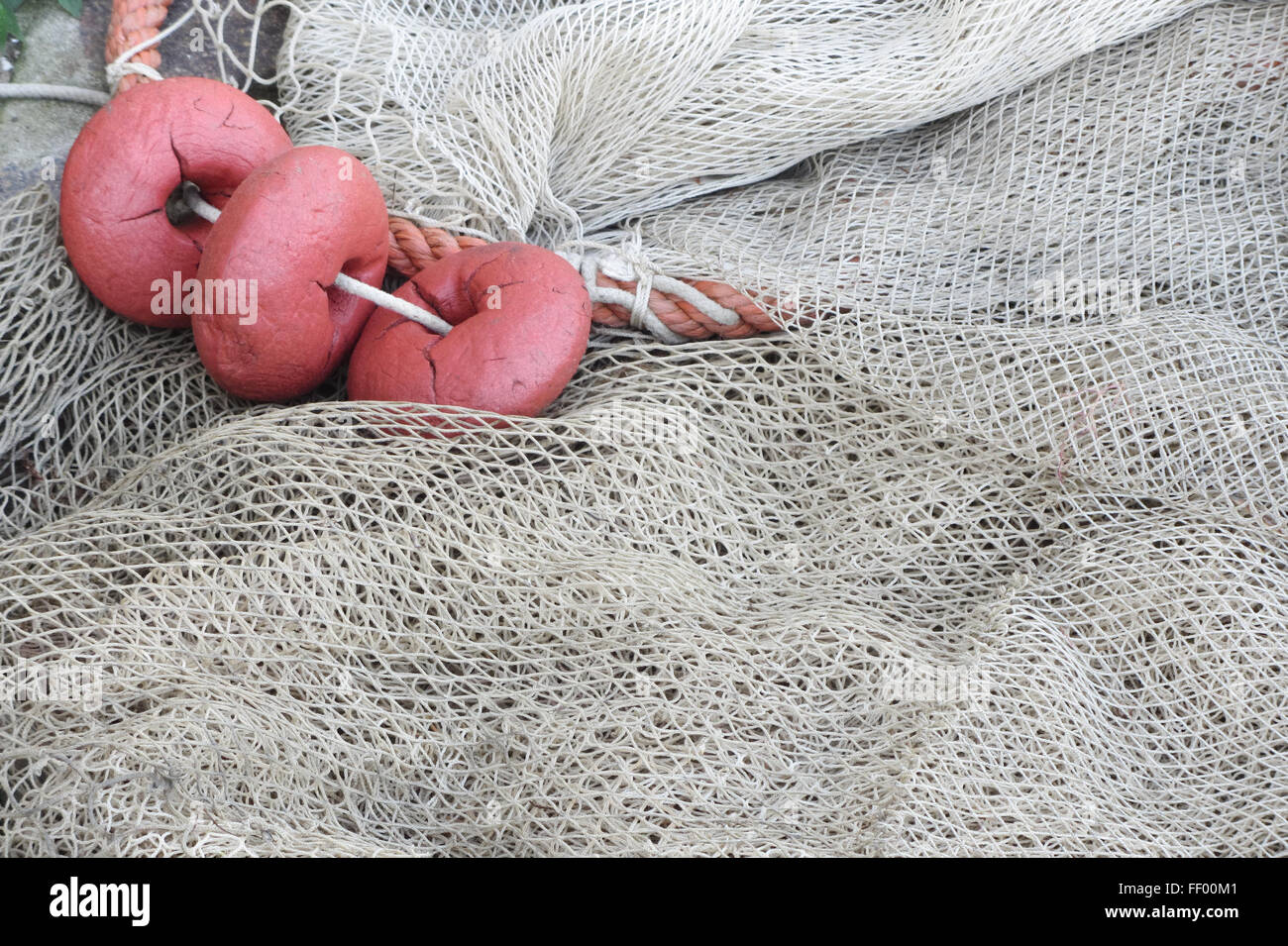 Used fishing net with floaters Stock Photo - Alamy