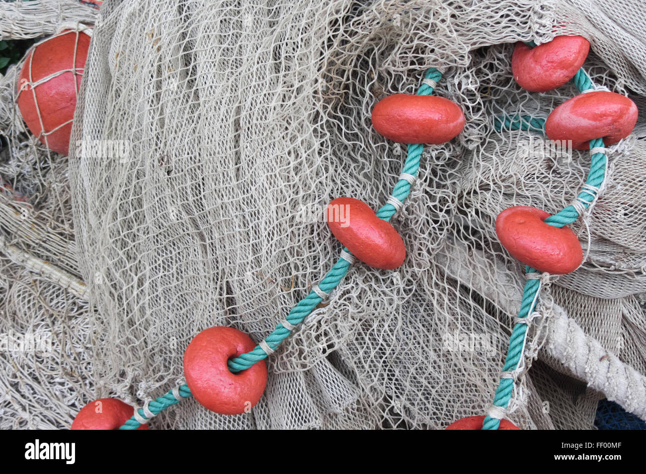 Used fishing net with floaters Stock Photo - Alamy
