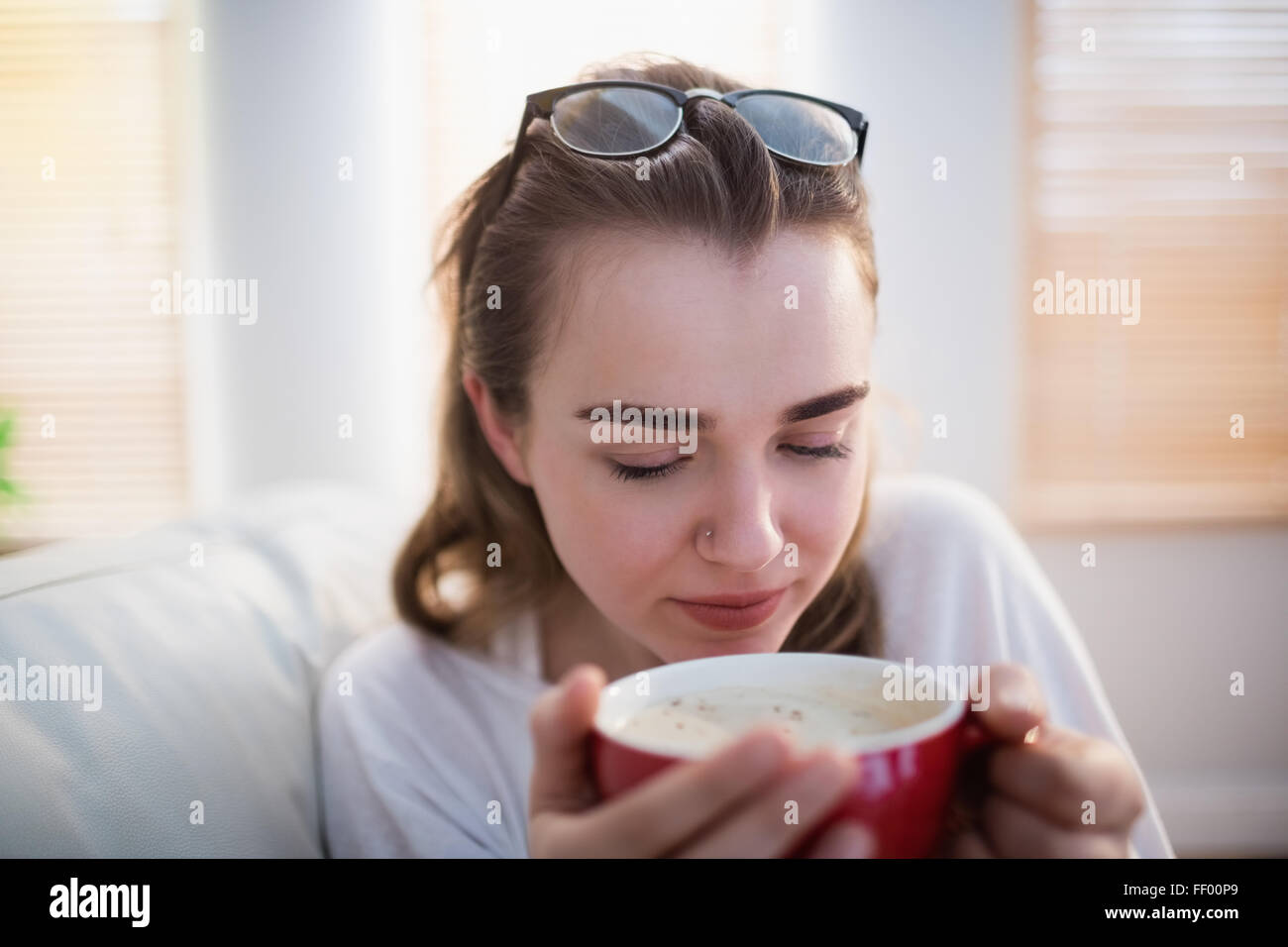 Woman relaxing on sofa sipping hi-res stock photography and images - Alamy