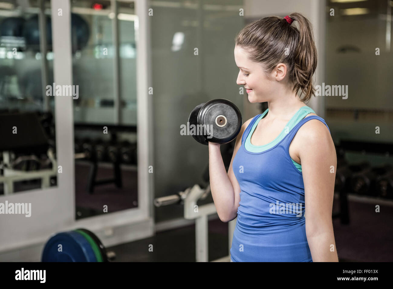 Strong woman lifting dumbbell workout hi-res stock photography and ...