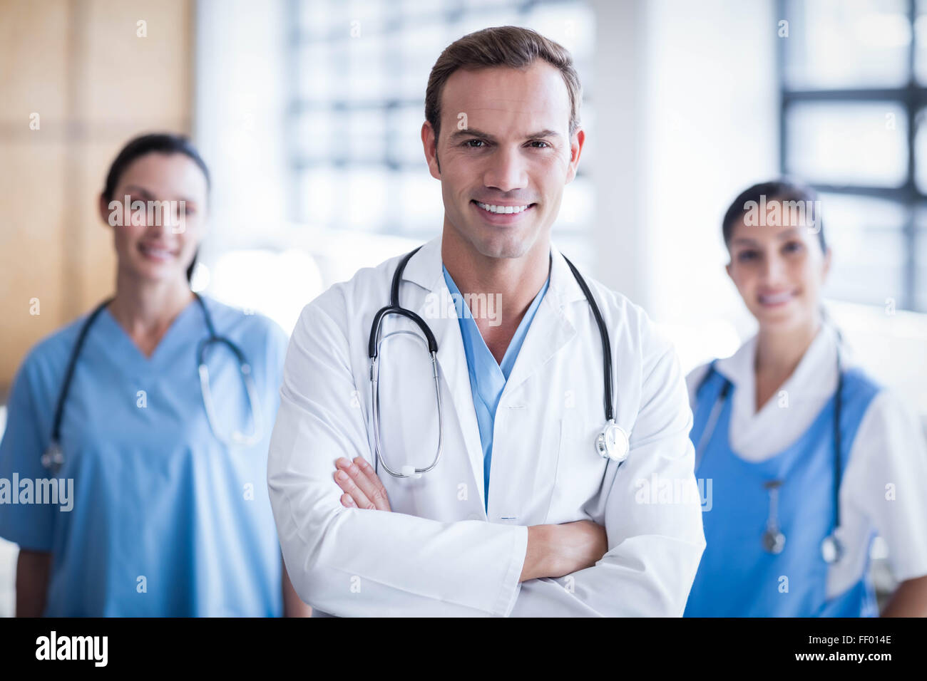 Smiling medical team with arms crossed Stock Photo - Alamy