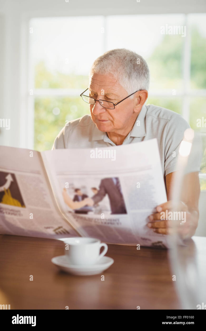 Focused senior man reading newspaper Stock Photo - Alamy
