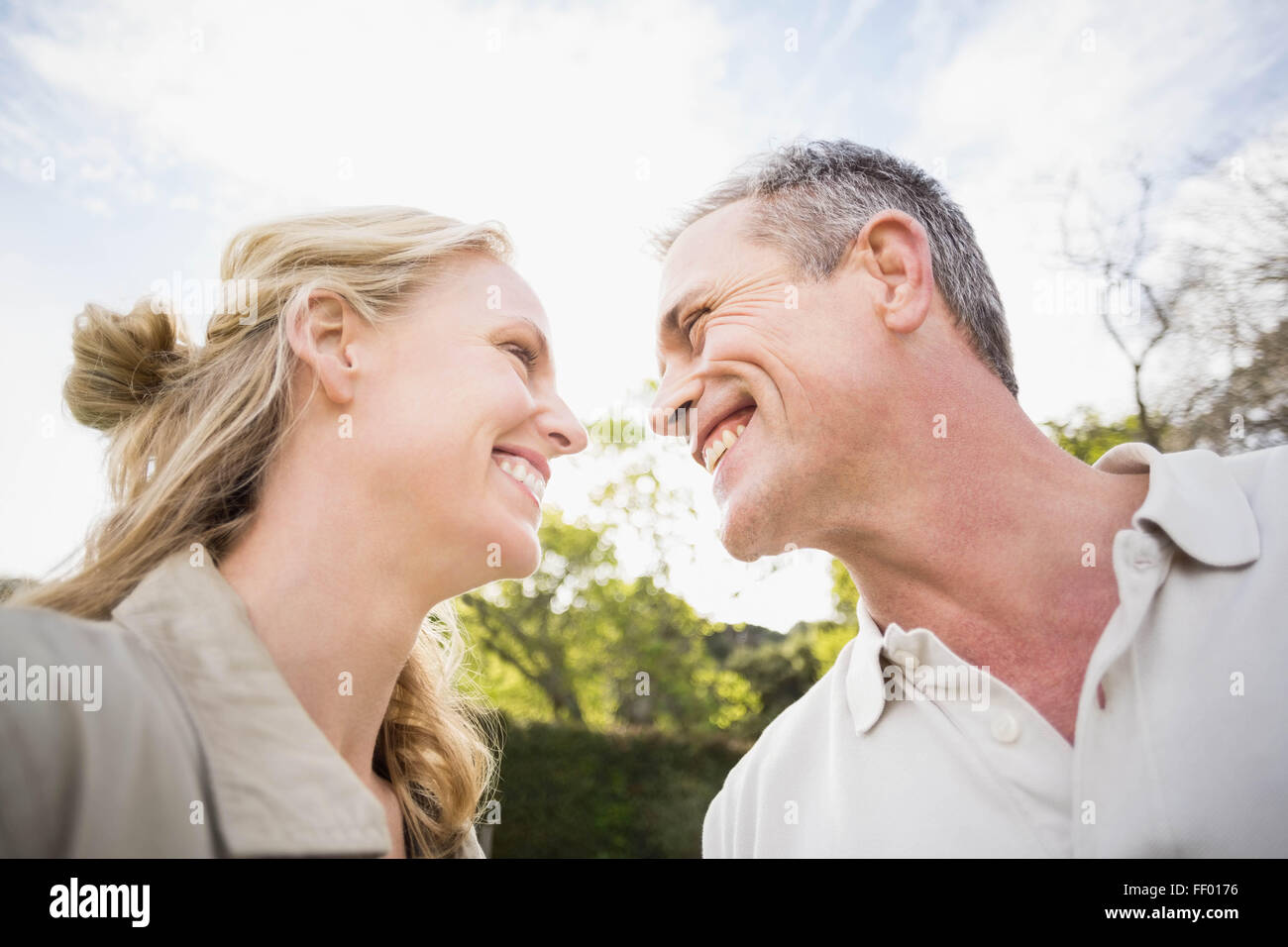 Cute couple smiling at each other Stock Photo - Alamy