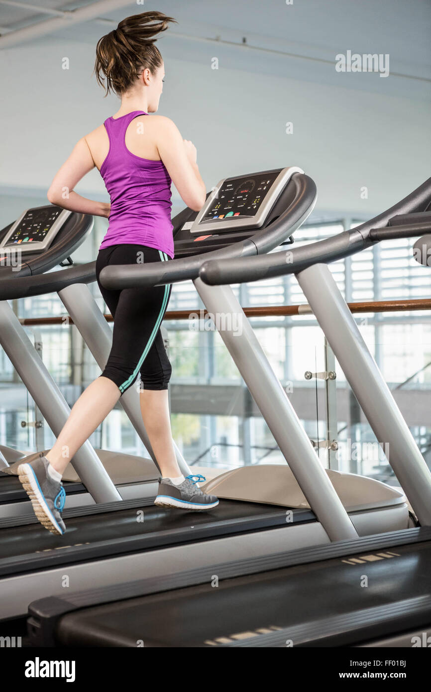Fit brunette running on treadmill Stock Photo - Alamy