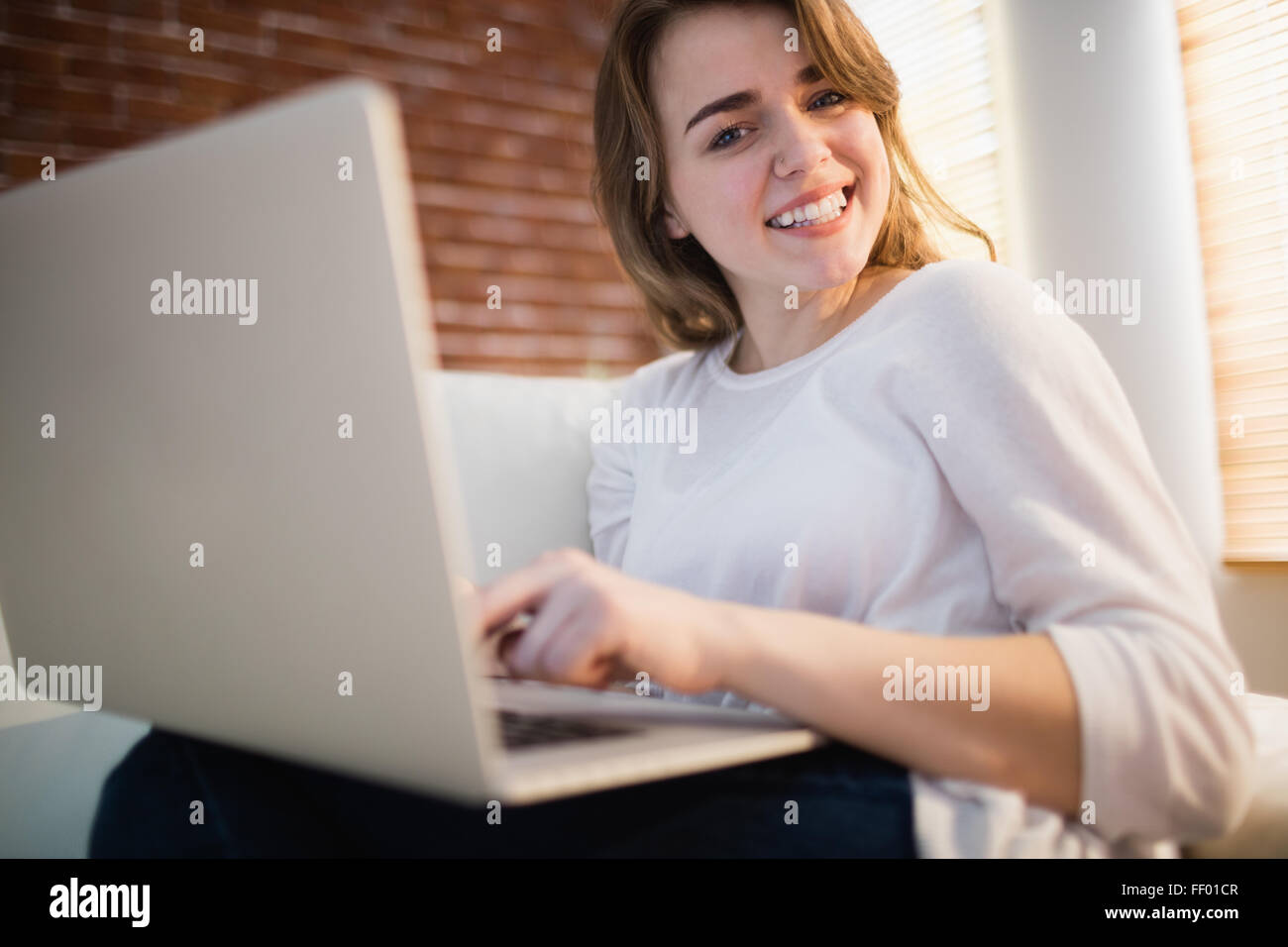 Pretty woman using her laptop Stock Photo - Alamy