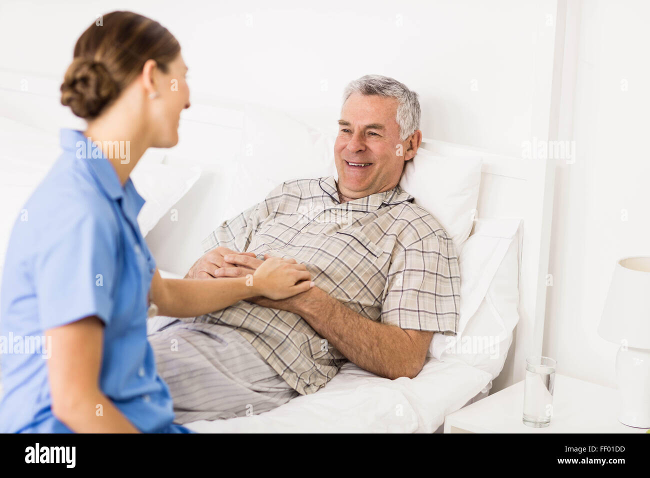Nurse taking care of suffering senior patient Stock Photo - Alamy
