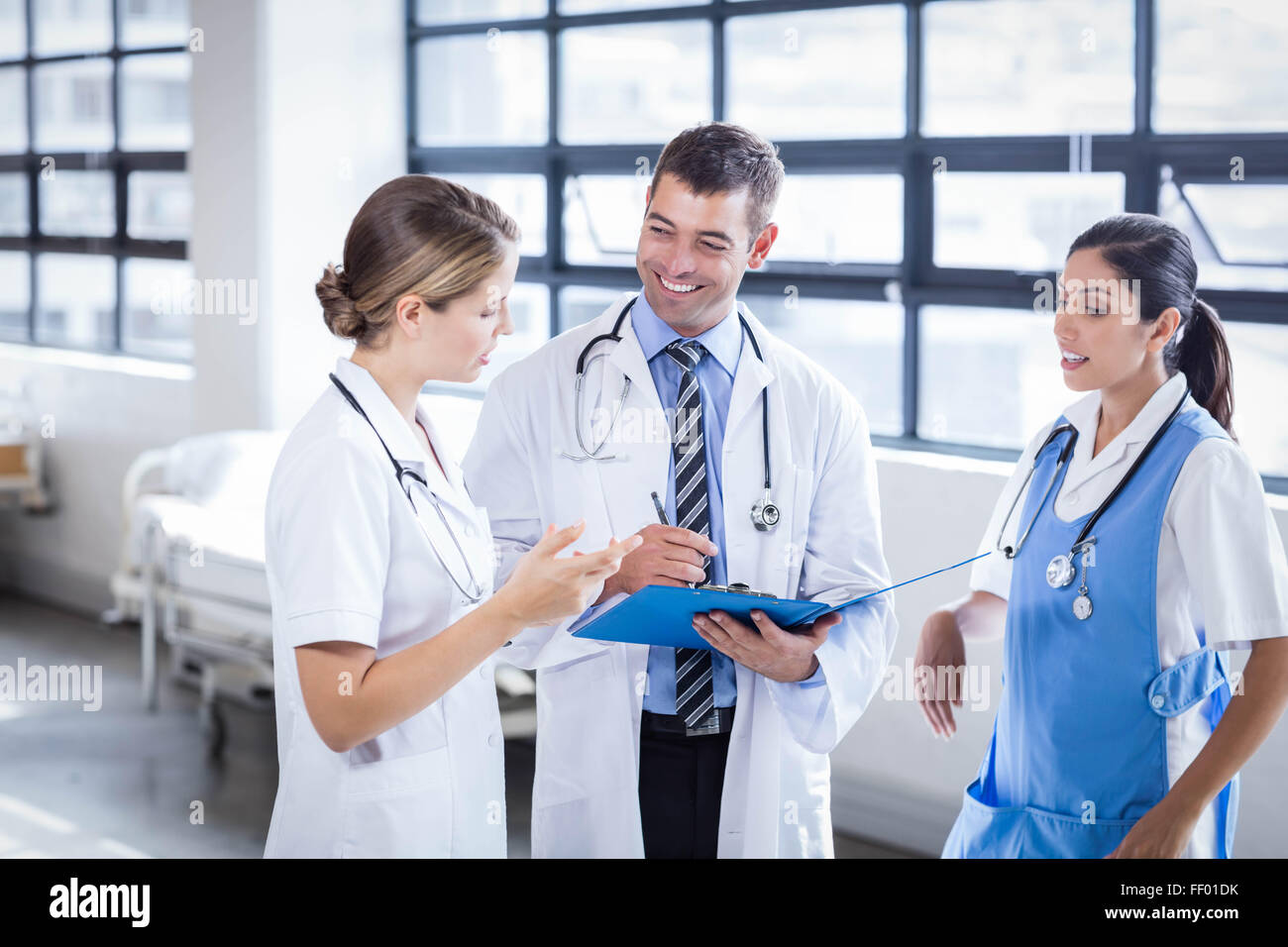 Medical team standing and talking Stock Photo - Alamy