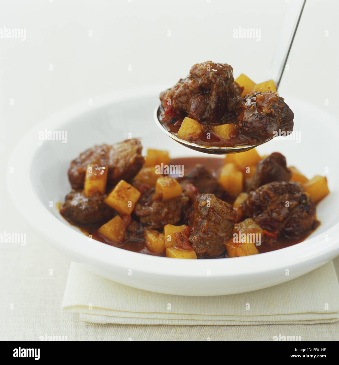 Wild boar ragout being ladled into bowl, close up Stock Photo - Alamy
