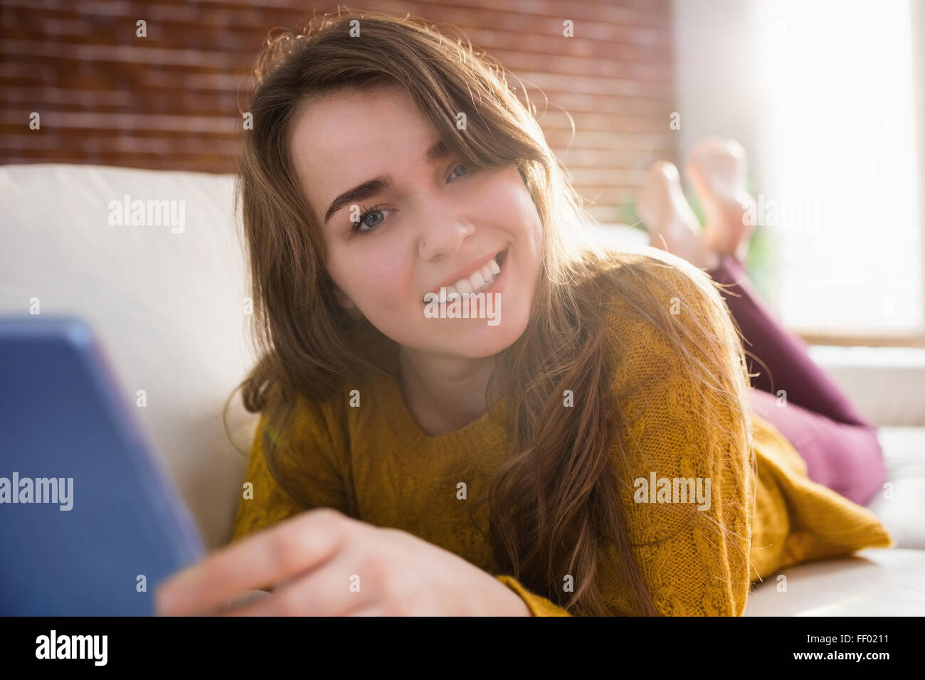 Smiling pretty woman using tablet Stock Photo - Alamy
