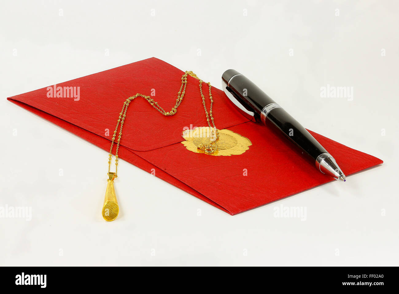 Golden necklace and a red envelope Stock Photo - Alamy