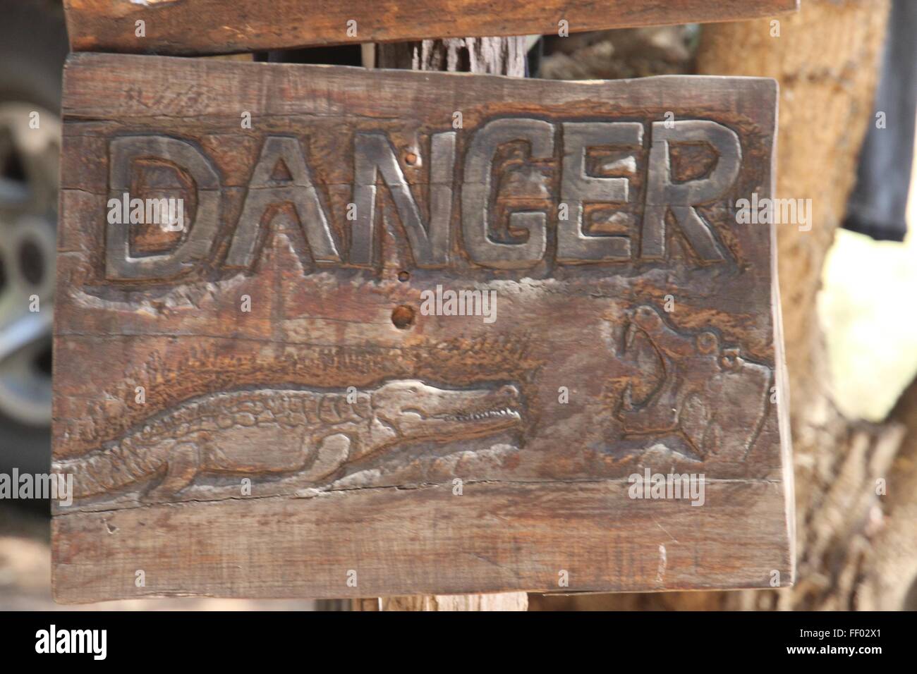 Danger sign for crocodiles and hippos with a hippo with his mouth open ...