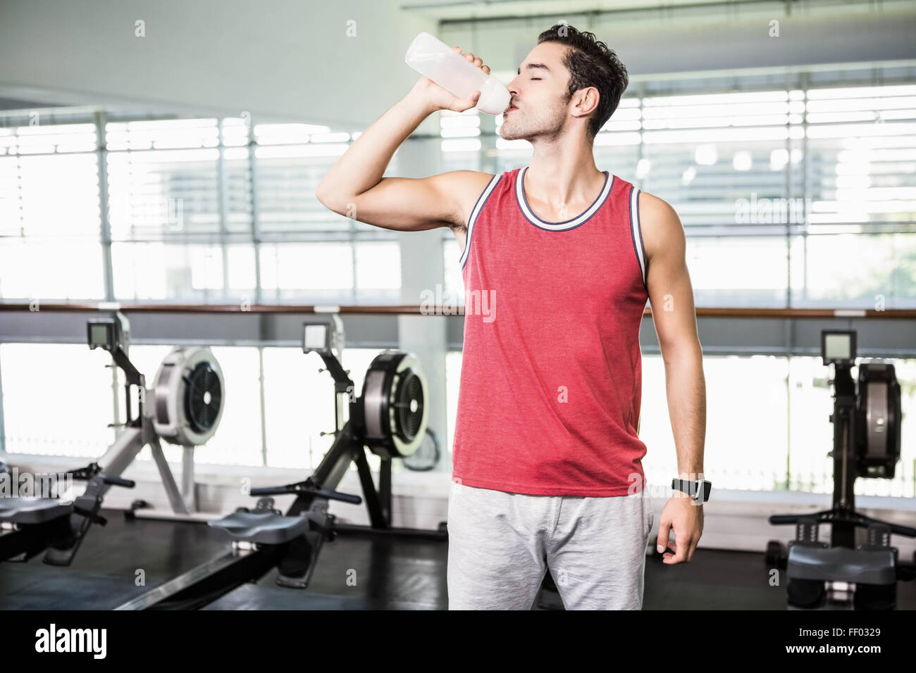Standing man drinking water Stock Photo - Alamy