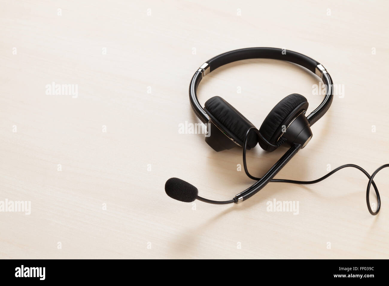 Office desk with headset. Call center support table. View with copy ...