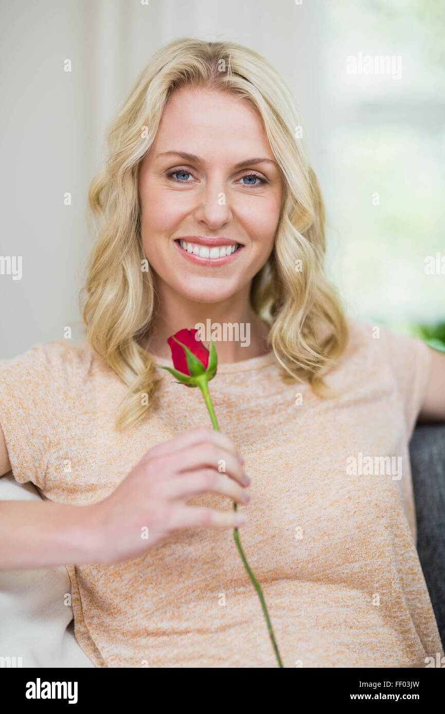 Pretty woman smelling a rose Stock Photo - Alamy