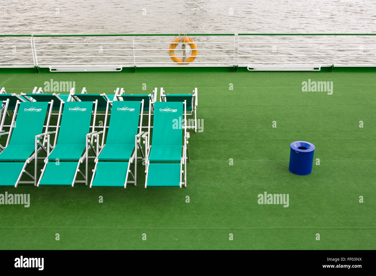 Europe, Germany, Cologne, sunloungers and trash can on the deck of a ...