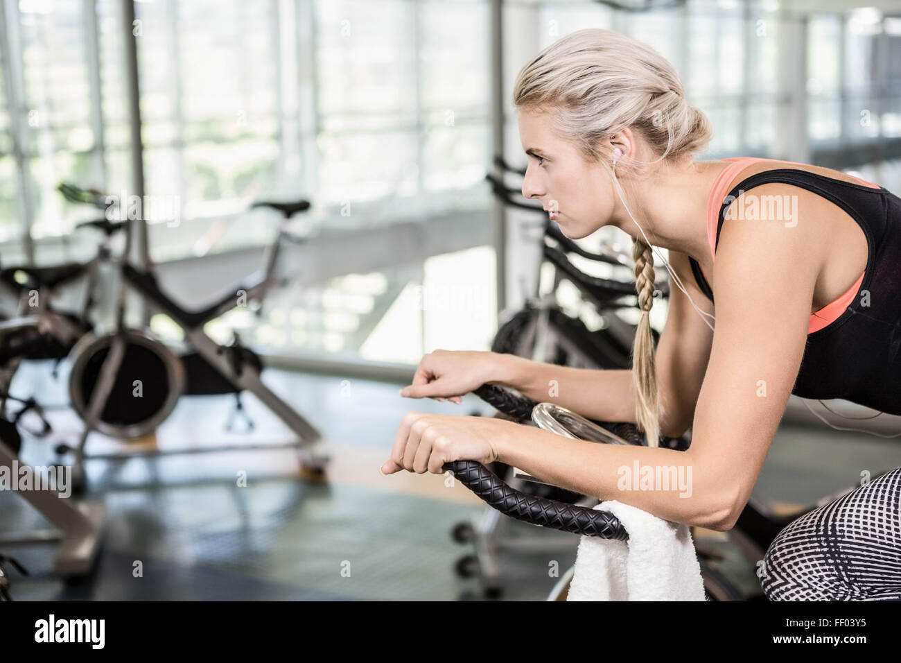 Fit woman on exercise bike Stock Photo - Alamy