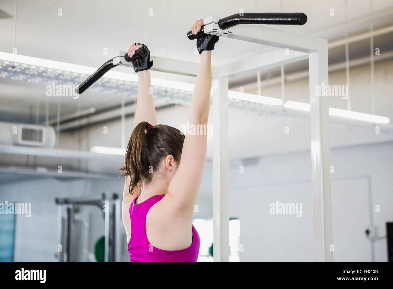 Fit woman doing pull up Stock Photo - Alamy