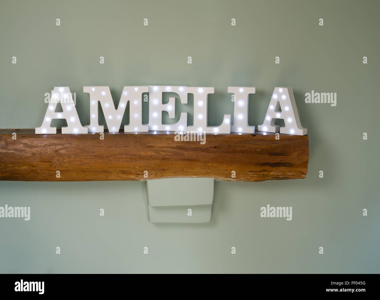 The girls name AMELIA in lit up letters on a wooden mantelpiece Stock ...