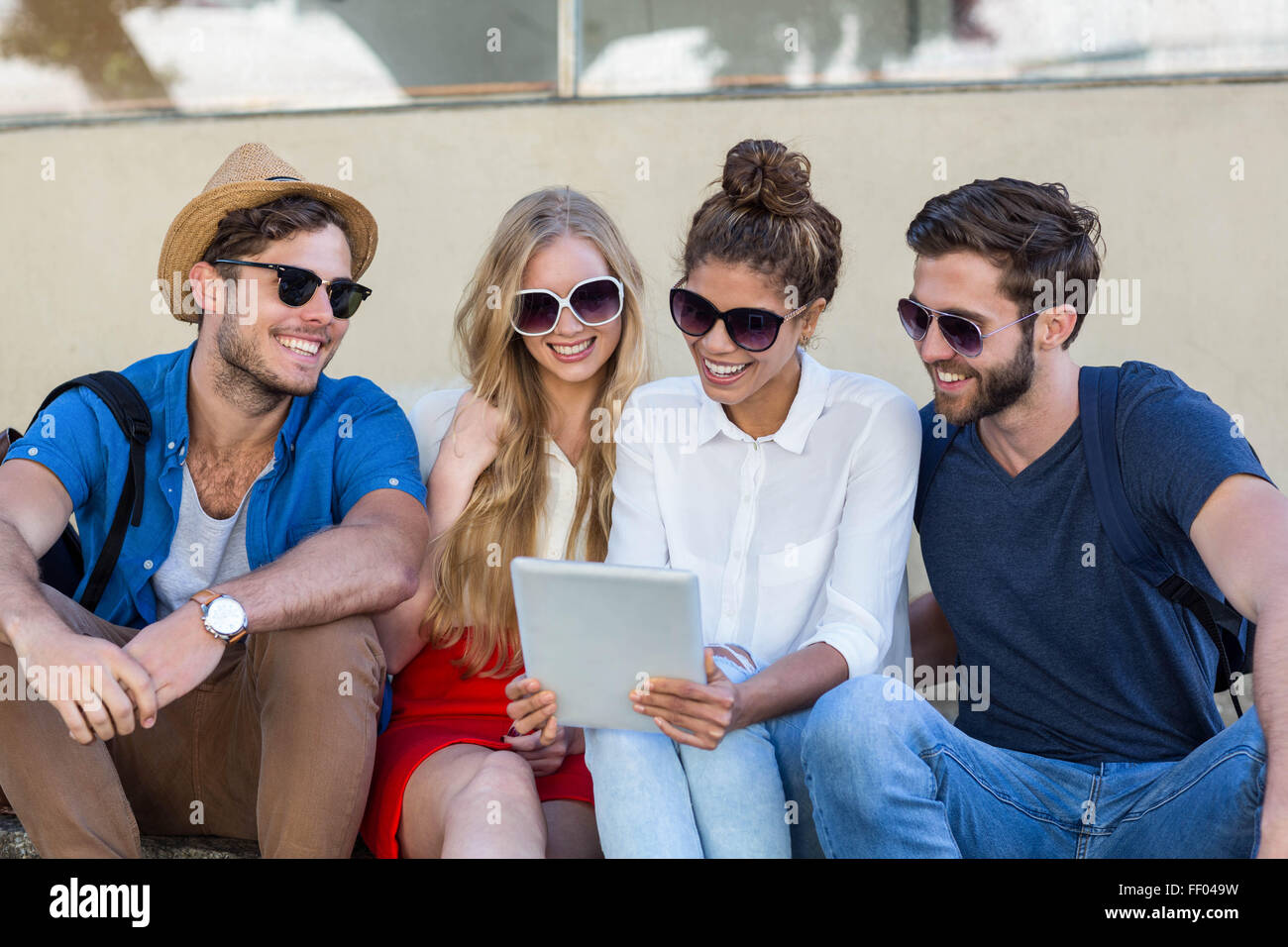 Hip friends looking at table Stock Photo - Alamy
