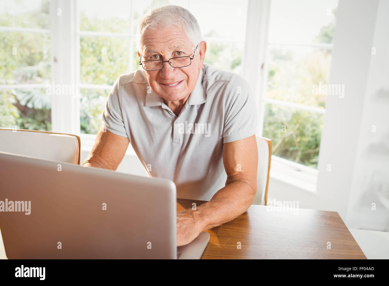 Smiling senior man typing hi-res stock photography and images - Alamy