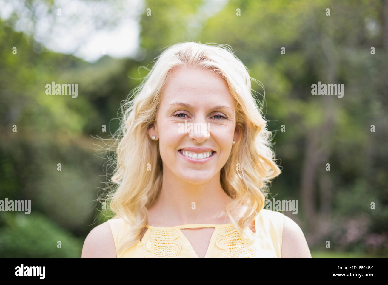 Cute woman smiling at camera Stock Photo - Alamy