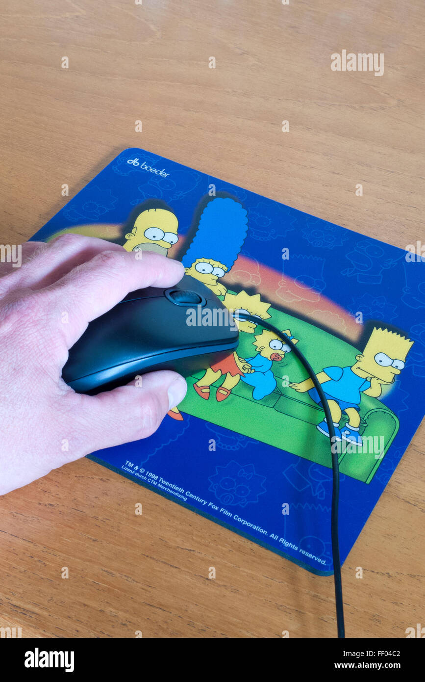 Caucasian Man's Hand Using a Computer Mouse with Simpson's Mousemat, UK ...