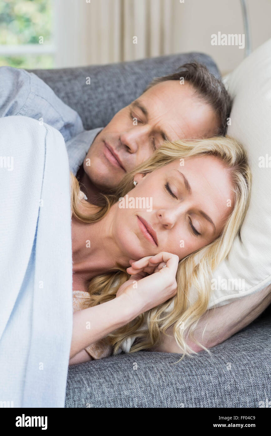 Cute couple napping on the couch Stock Photo - Alamy