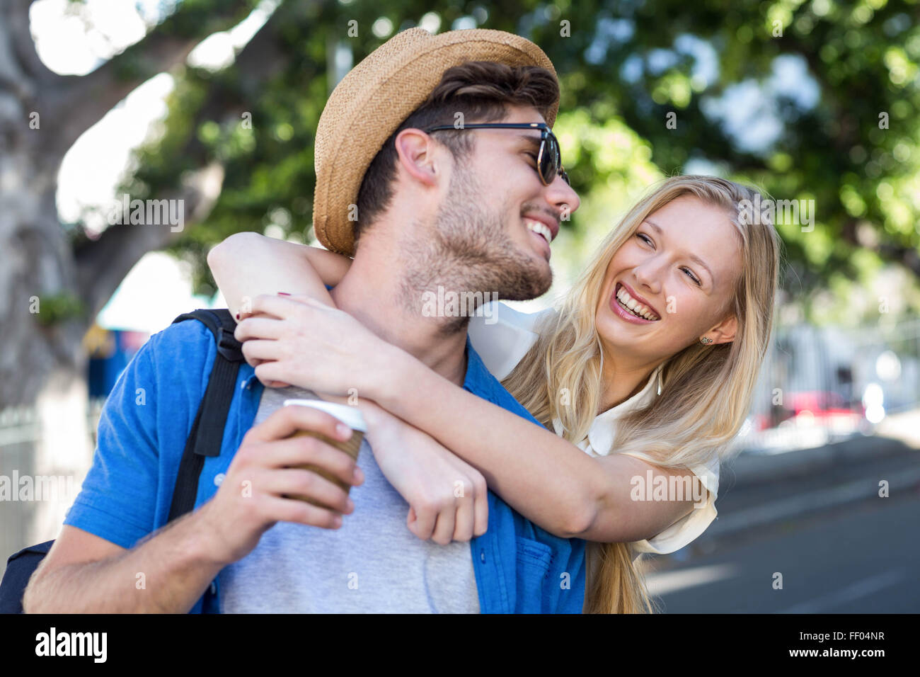 Hip couple embracing and laughing Stock Photo - Alamy