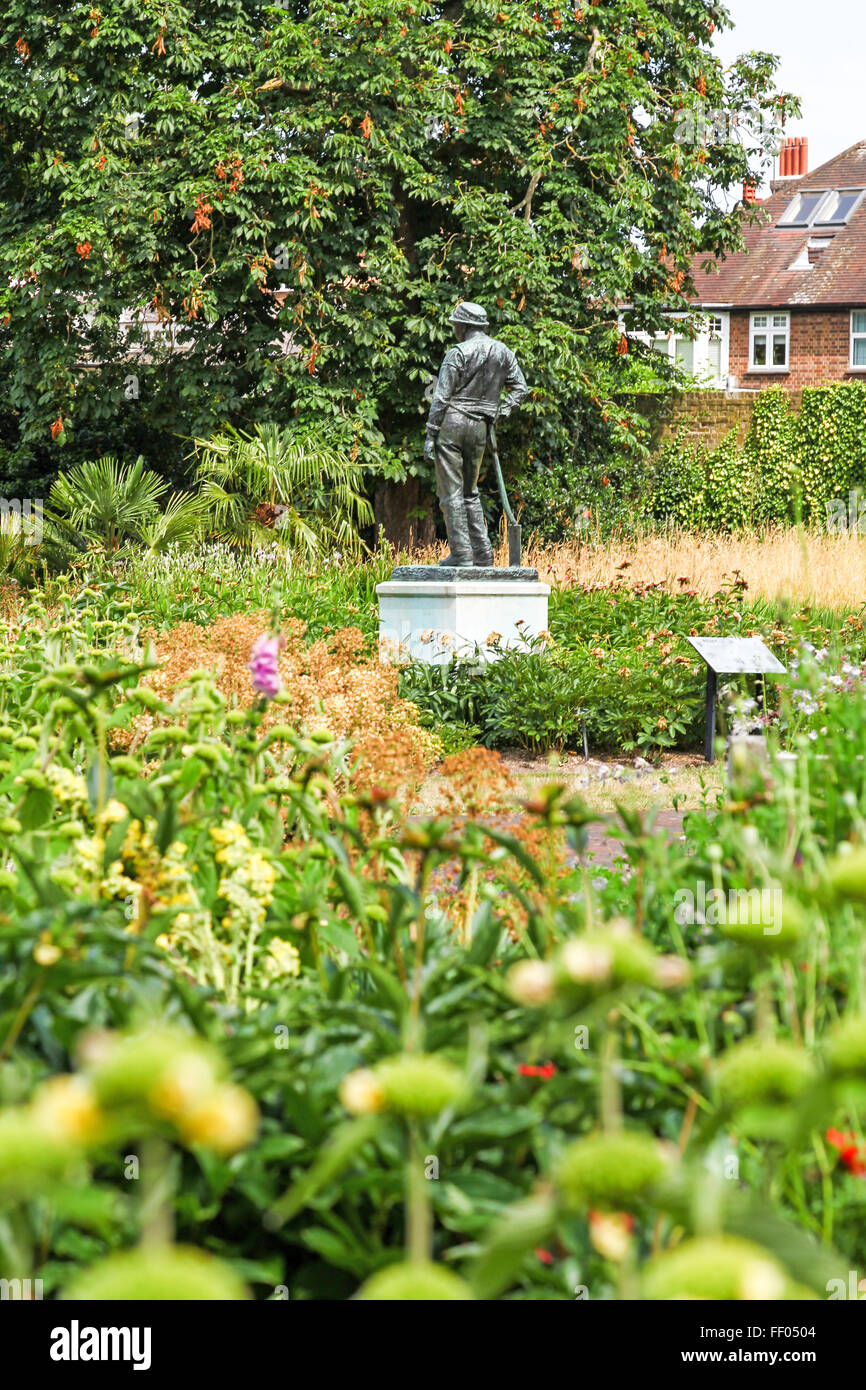 Bronze statue of a young man with a shovel entitled Out in the Fields ...