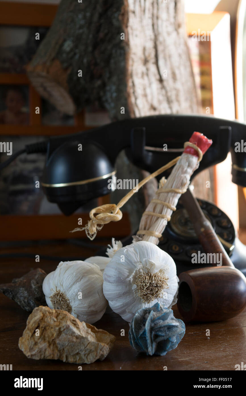 garlic string photographed with natural light on a wooden commode Stock ...