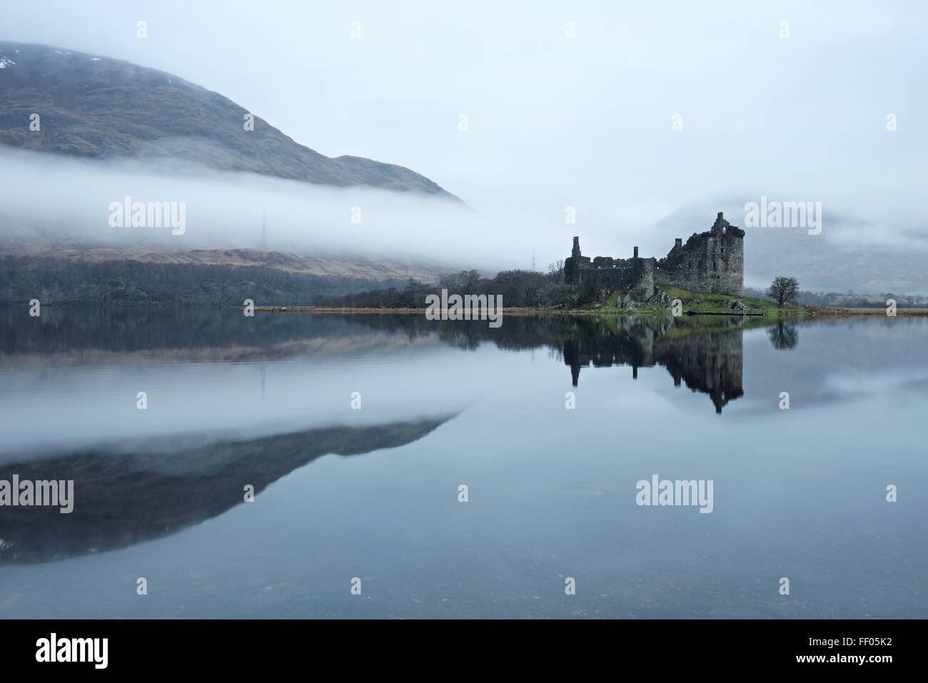 Bands of mist shrowd Kilchurn castle on a overcast winters morning ...