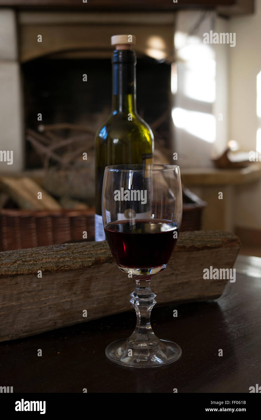 goblet of red wine on a wooden table photographed with natural light ...