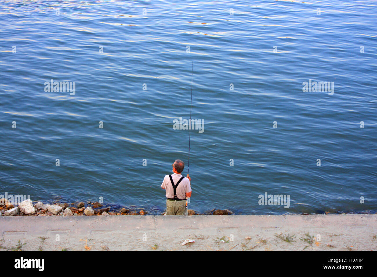 Old man fishing in the river Stock Photo - Alamy