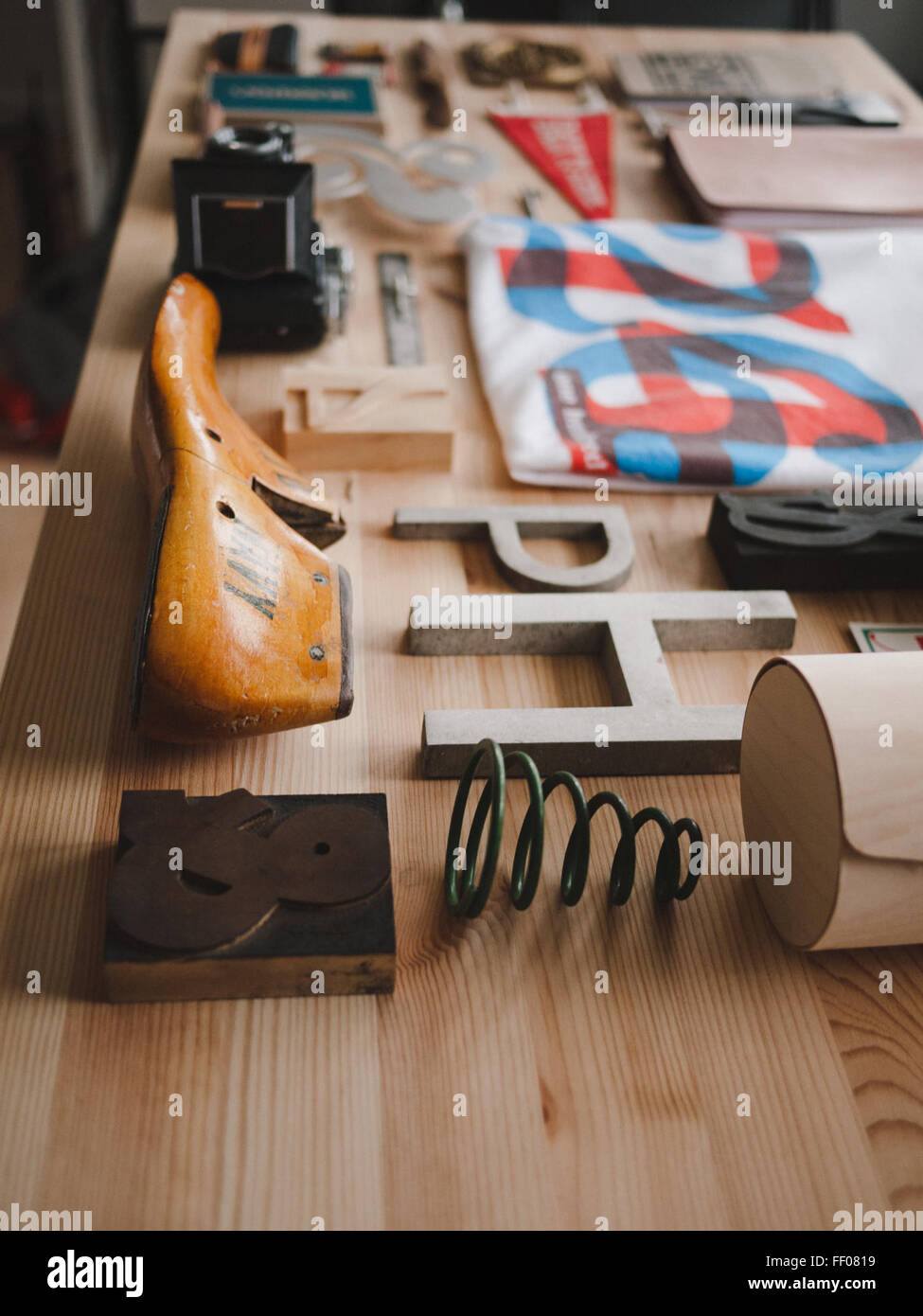 A desktop still life featuring various items like letters, stamps, and ...