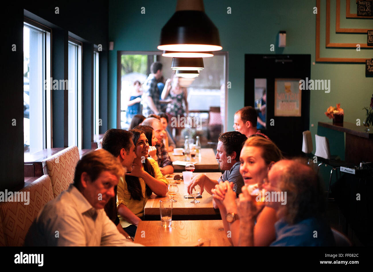 A bustling restaurant filled with patrons enjoying meals and ...