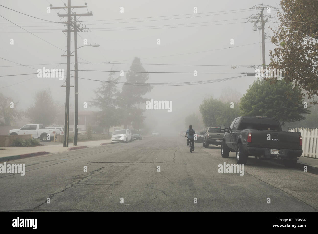 A street covered in smog, reflecting air pollution in urban ...