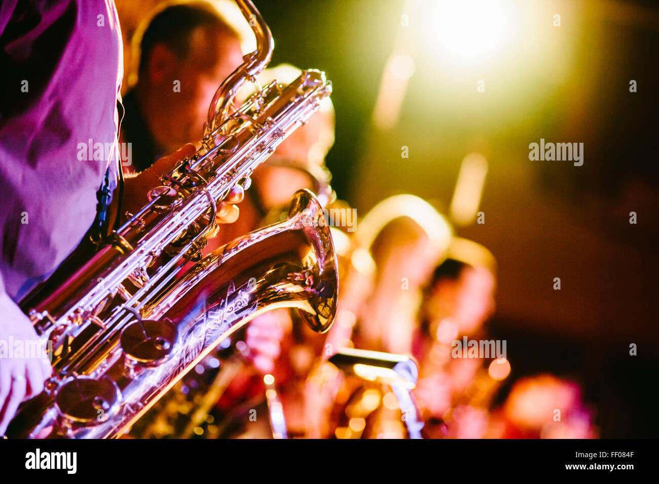 A musician plays a saxophone, creating music in a lively, dynamic ...