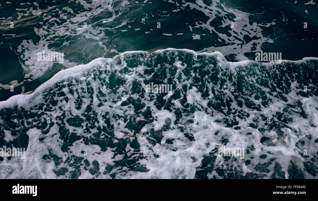 Ocean waves crashing with frothy water, depicting the dynamic movement ...