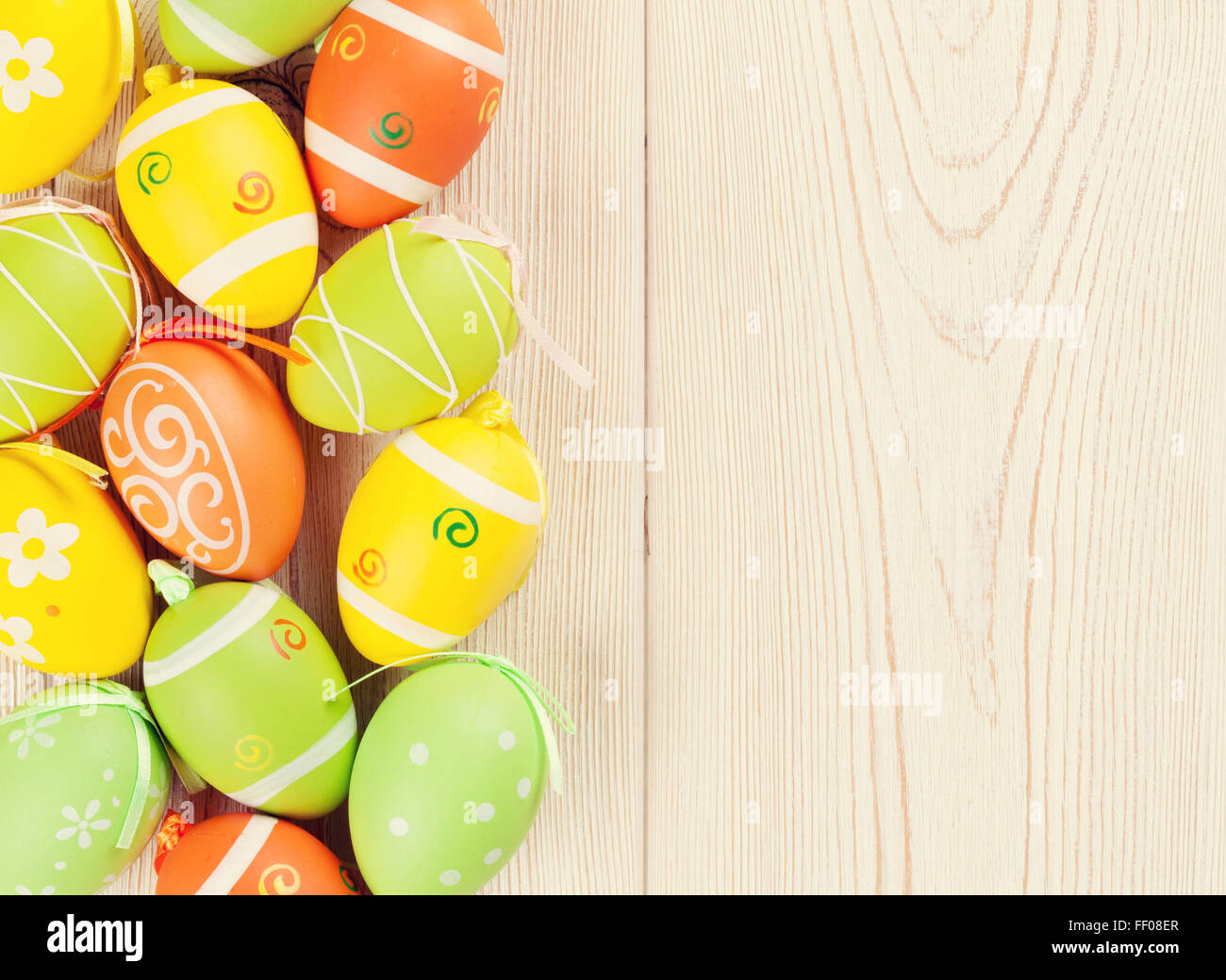 Easter background with colorful eggs over wooden table. Top view with ...
