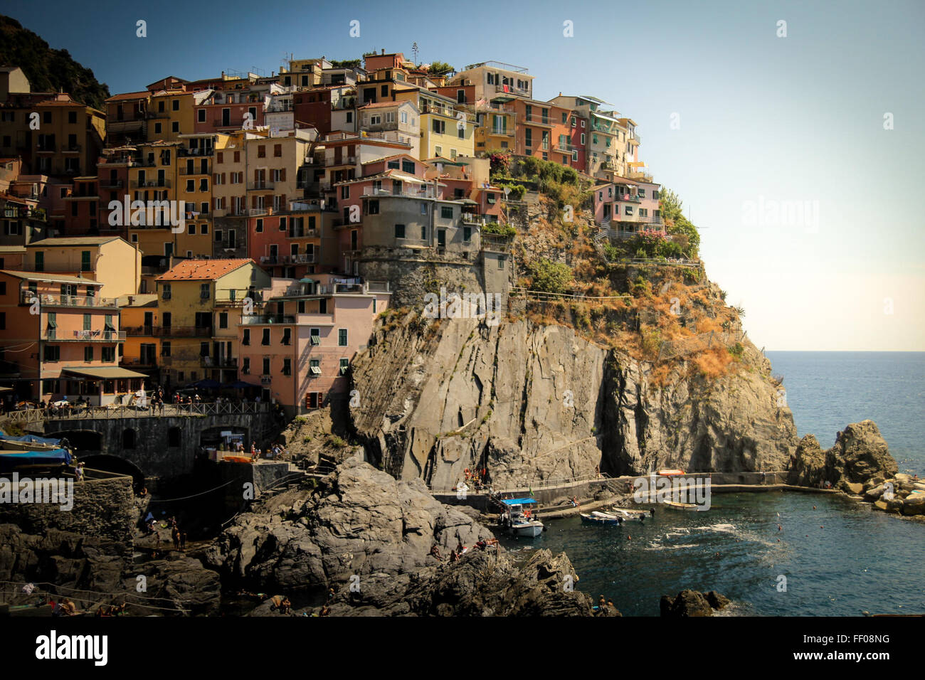 A coastal village with buildings and docks perched on the edge of a ...