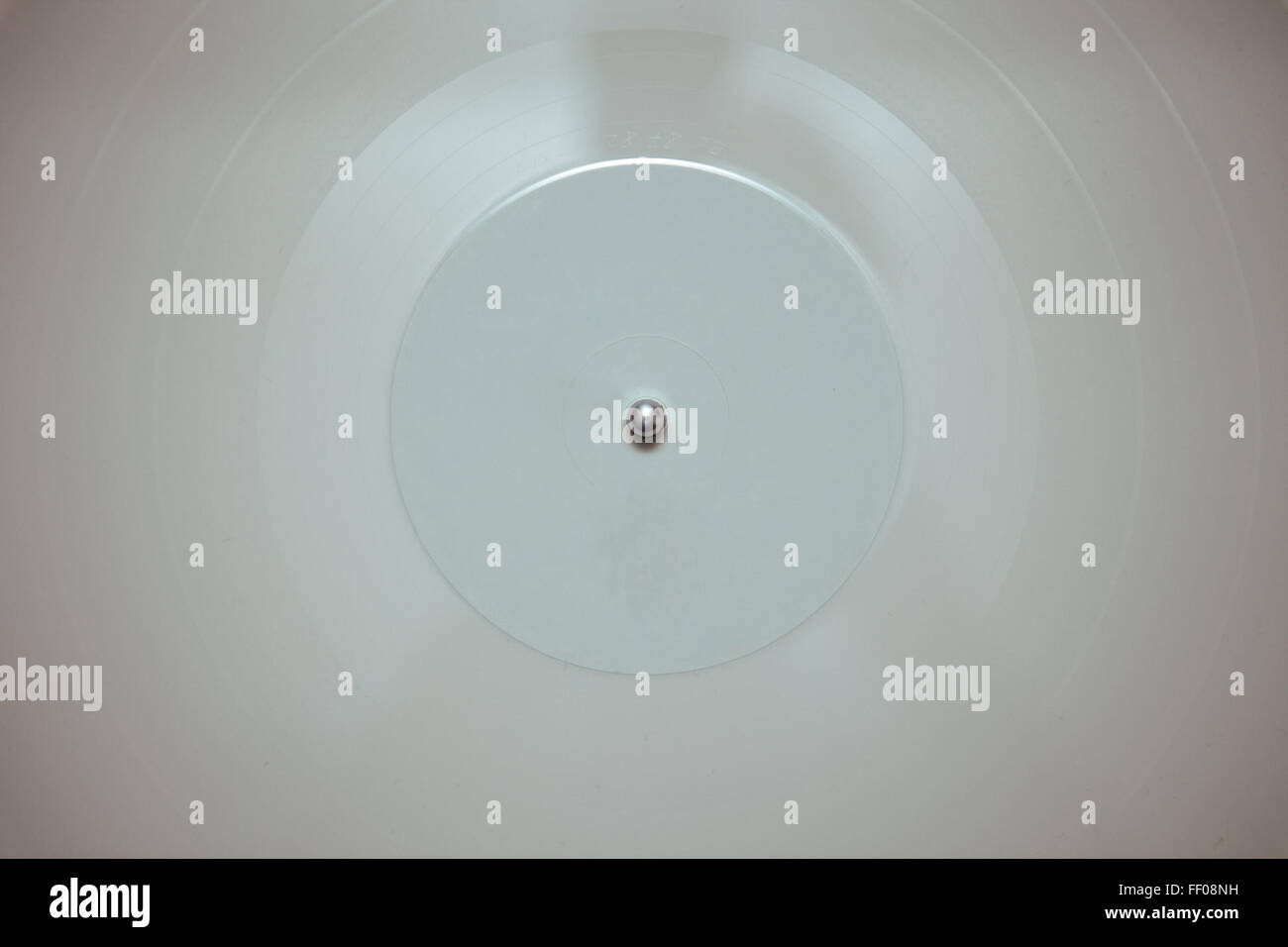 A white press with a record texture, positioned against a white ...