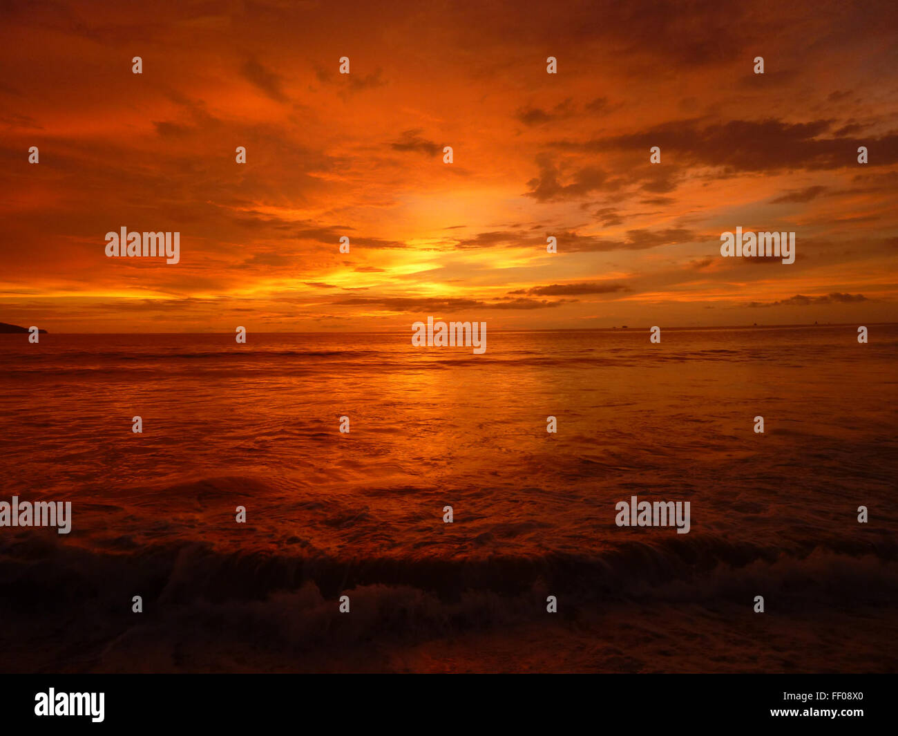 A beautiful sunset over the ocean, where the sky is painted in vibrant ...
