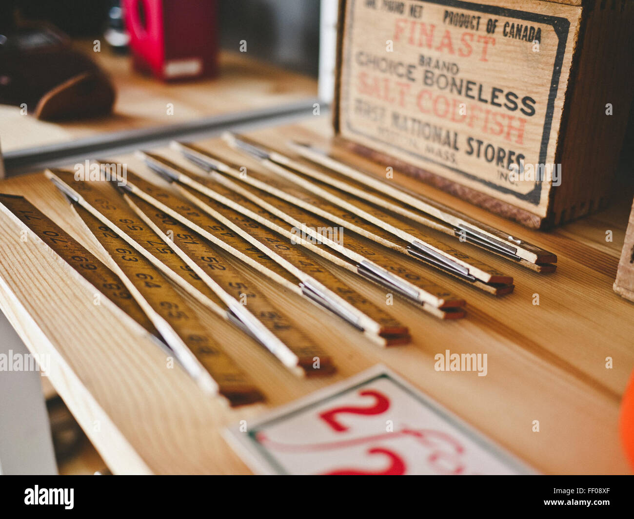 A vintage wooden ruler placed on a tabletop. The focus is on the ...