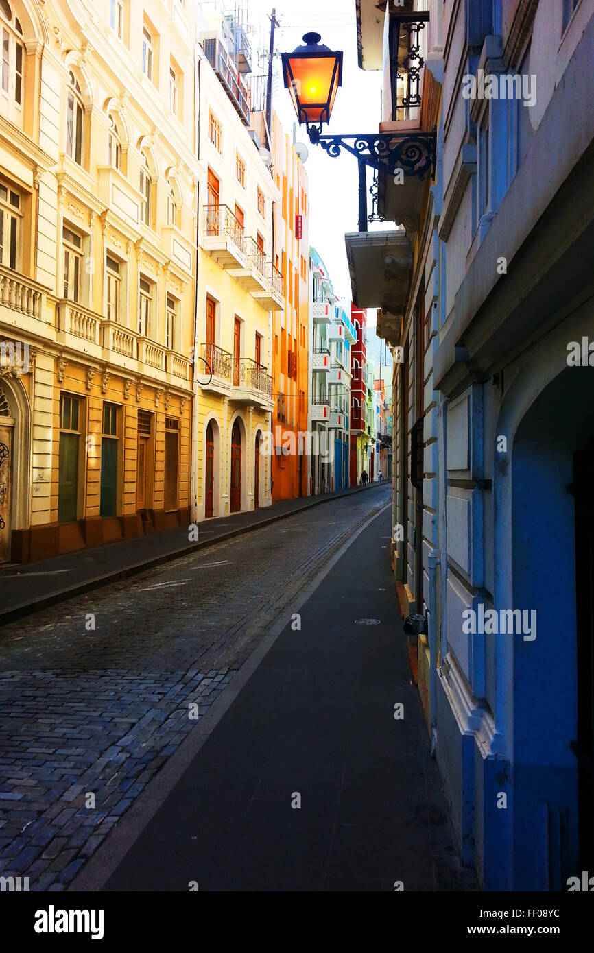 A narrow alleyway between colorful buildings, showcasing urban ...