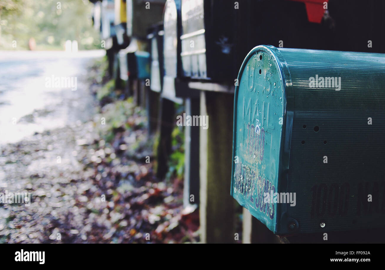 Rows of traditional mailboxes stand outdoors, typically seen in ...