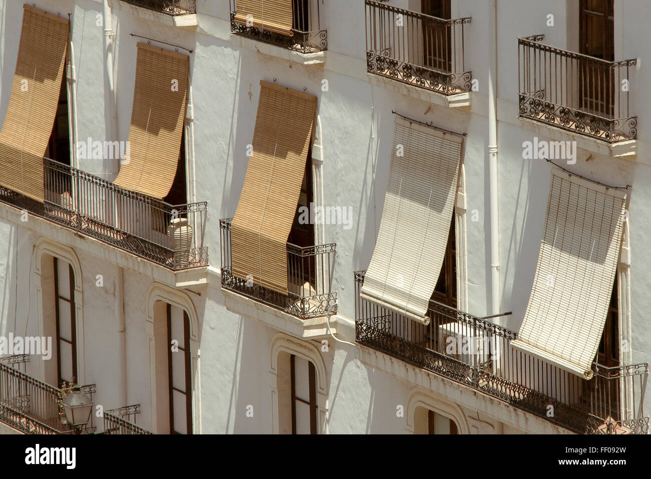 Window shades cover terraces in a modern architectural setting. The ...