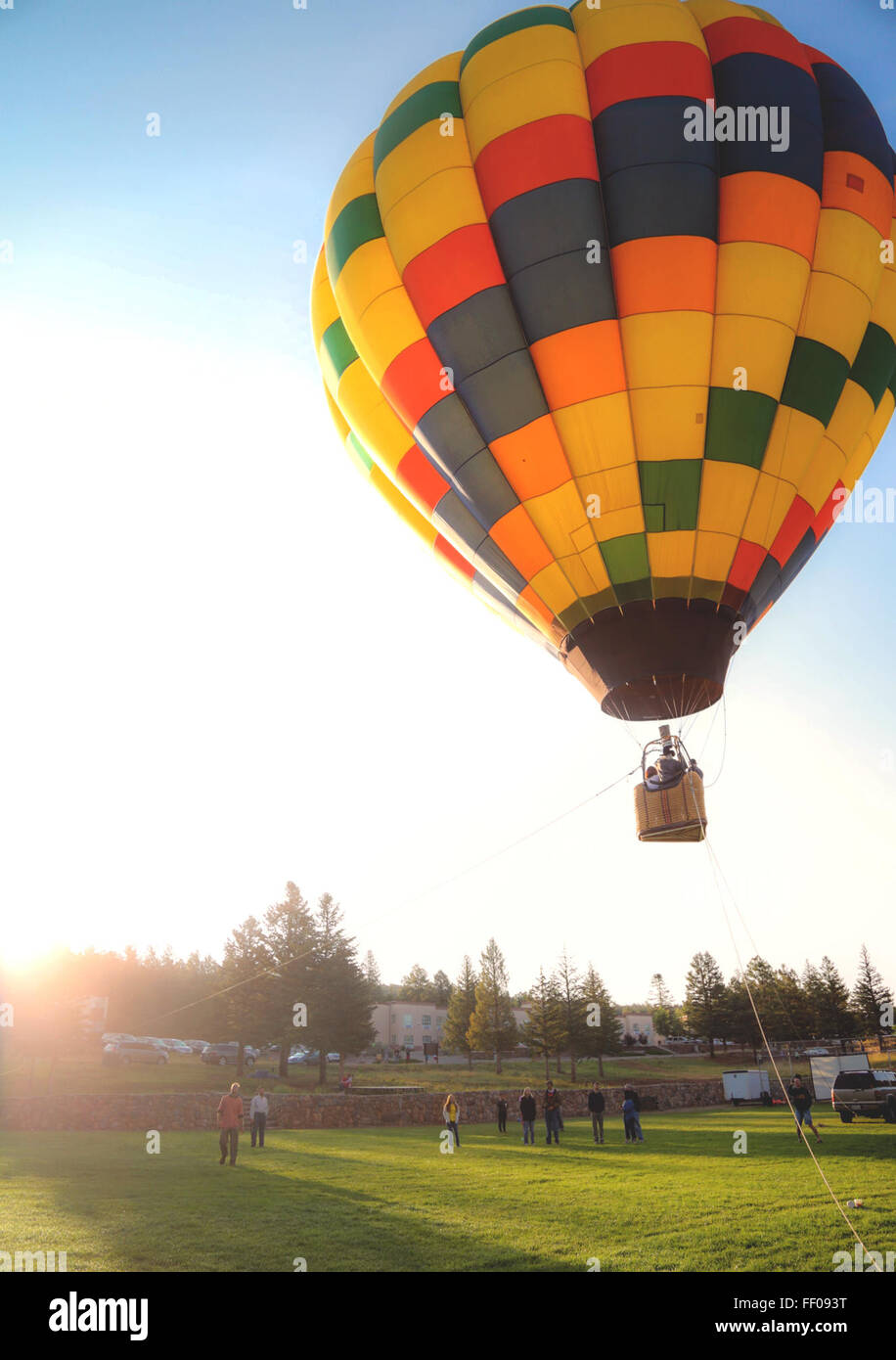 A colorful hot air balloon in flight, with a geometric pattern on its ...