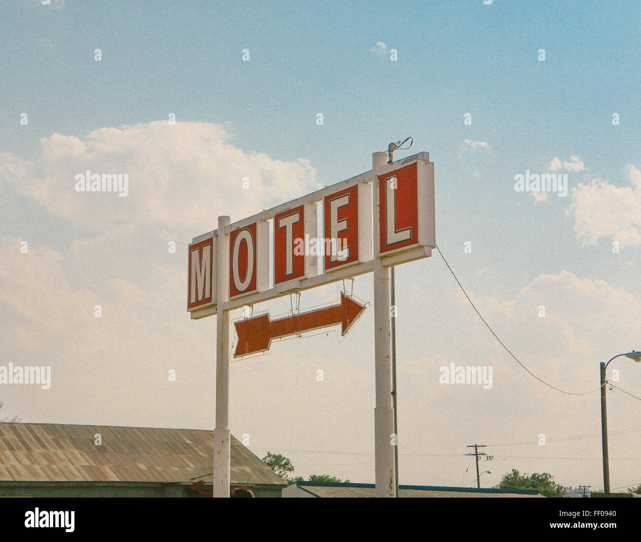 A vintage red and white motel sign featuring an arrow, with letters ...